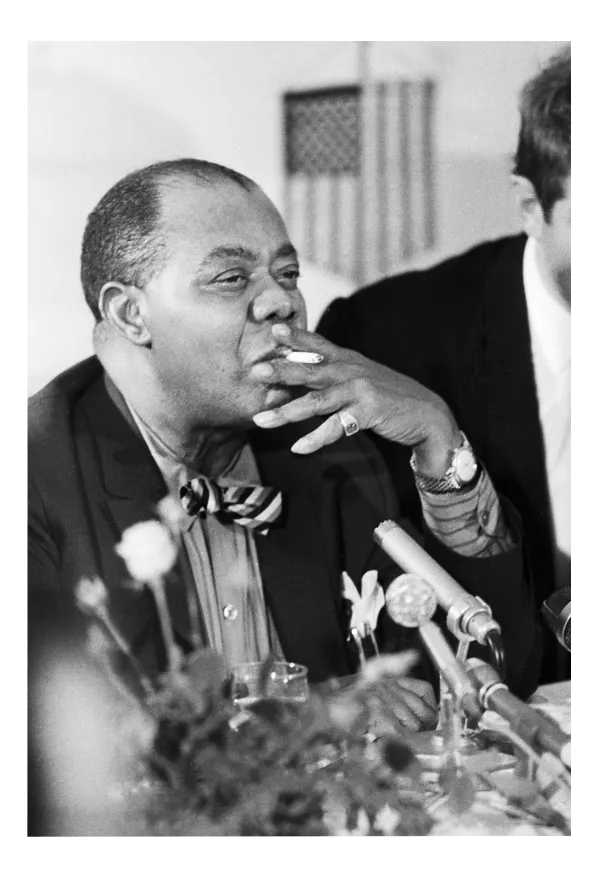 Louis Armstrong Smoking a Cigarette, Berlin, 1965 | Chairish