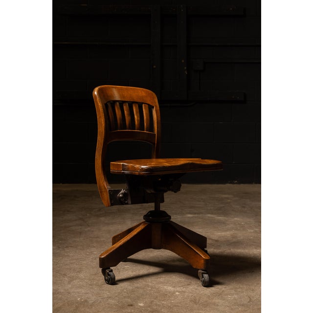 Early 20th Century Antique Wooden Rolling Banker's Chair | Chairish