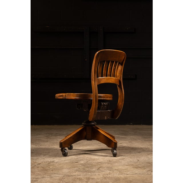 Early 20th Century Antique Wooden Rolling Banker's Chair | Chairish