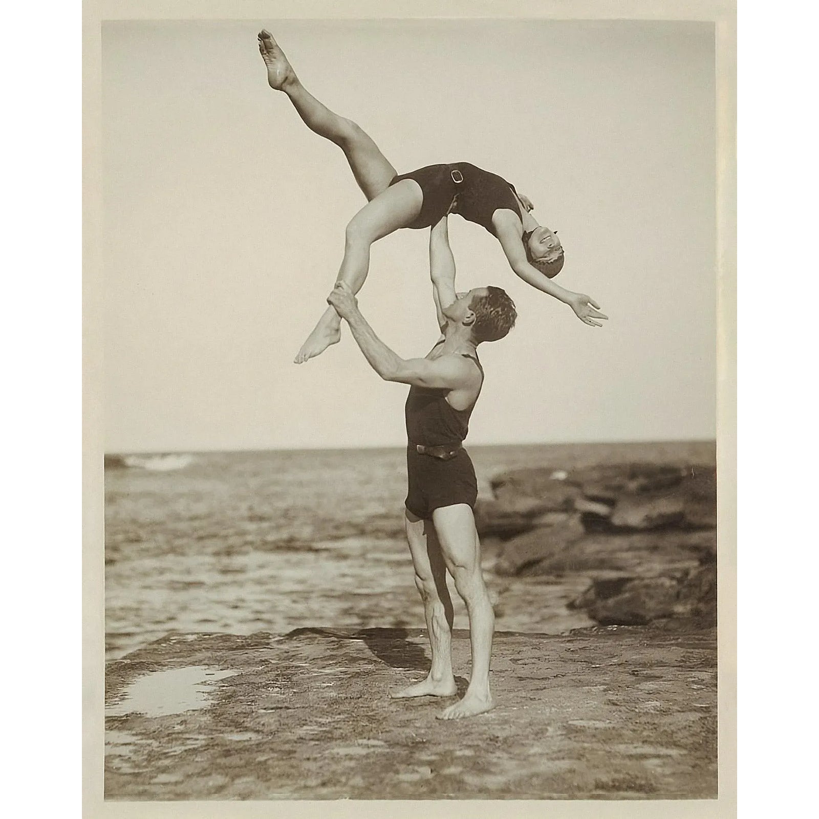 Reproduction Vintage Beach Photo With Acrobatic Couple | Chairish