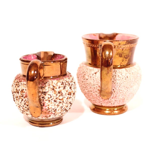 Pair Of Miniature Copper Lustre Ware Cream Pitchers With Low Relief